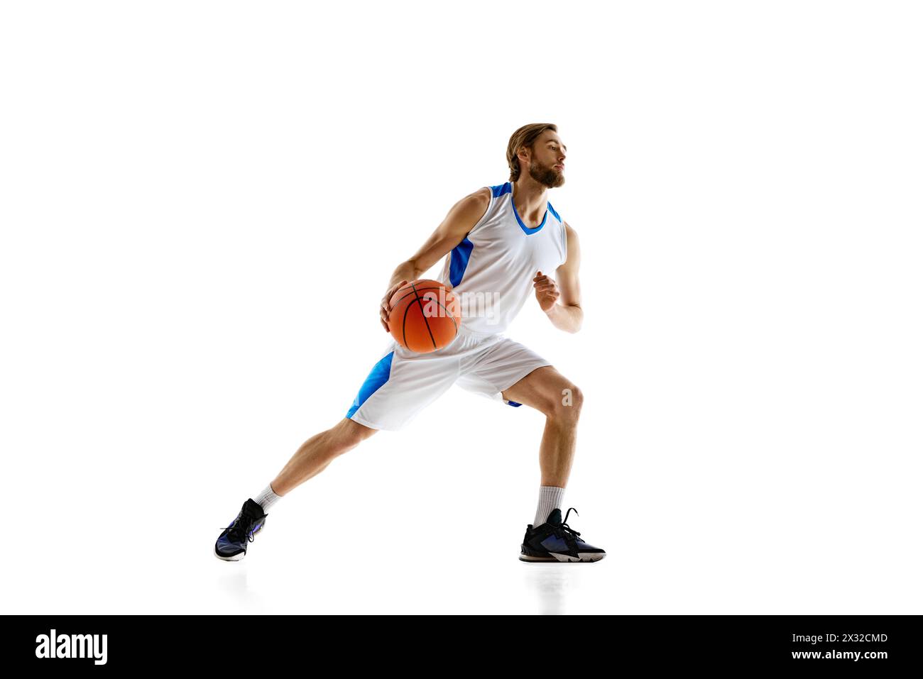 Skilled young man, basketball player in motion with ball demonstrating ...