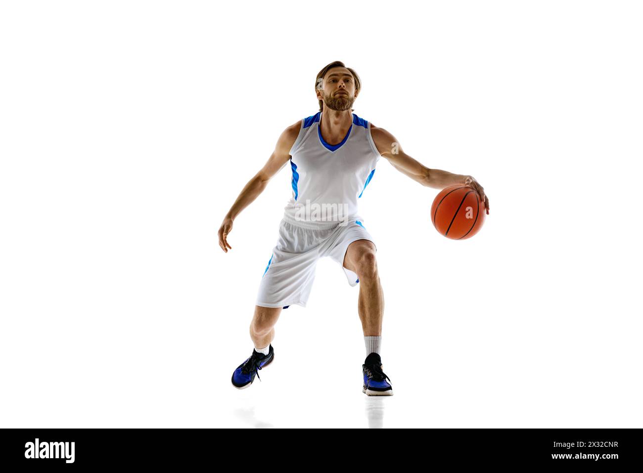 Competitive young man practicing. basketball player dribbling ball ...