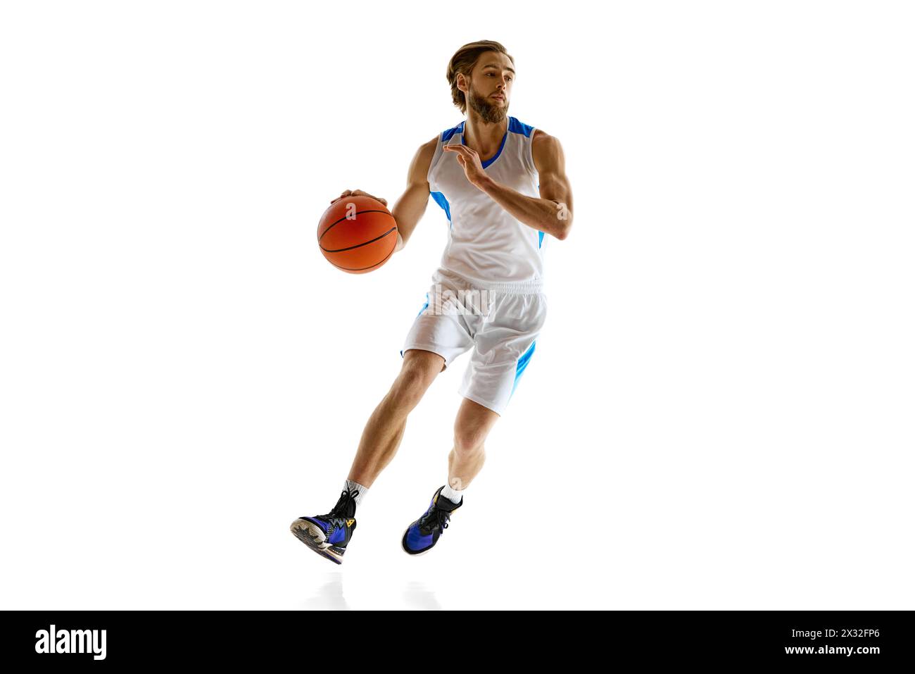 Competitive athlete practicing, basketball player in uniform in motion ...