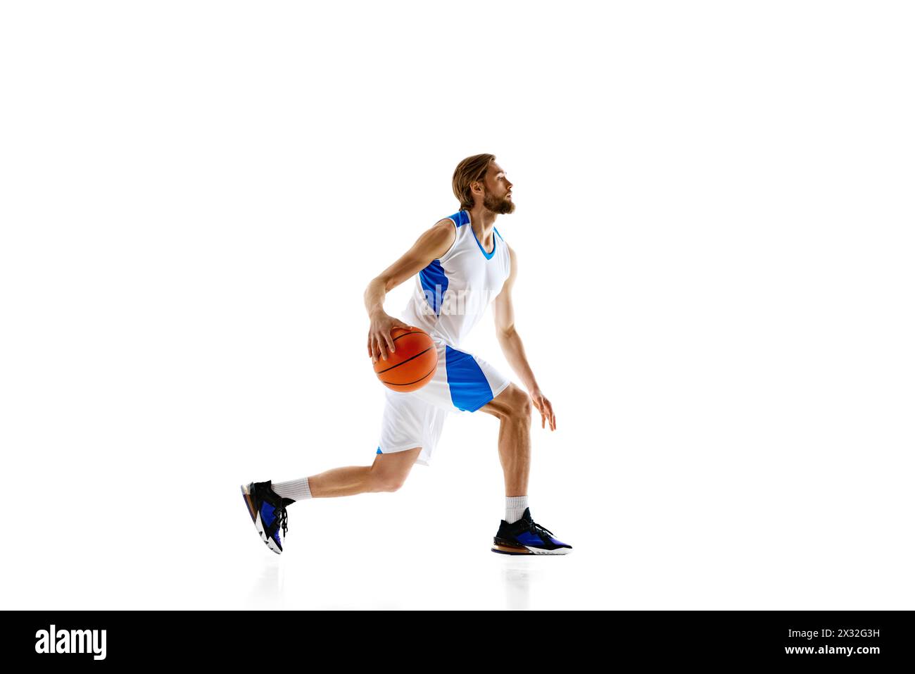 Competitive athlete practicing, basketball player in uniform in motion ...