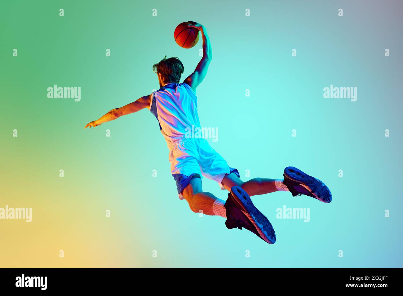 Competitive man, athlete in motion, training, playing basketball ...