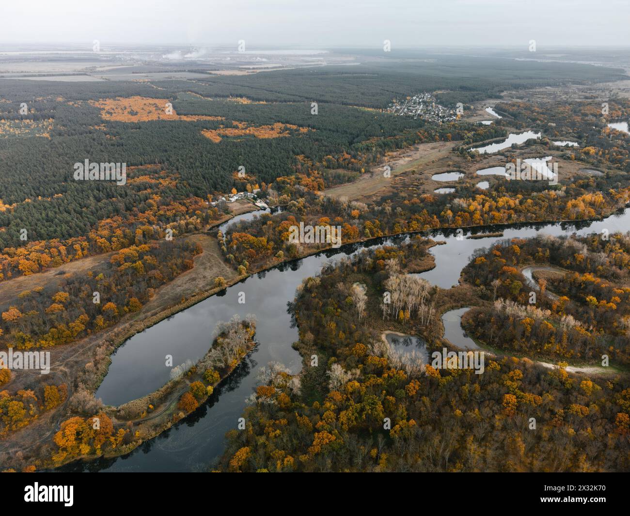 Aerial autumn river curves in colorful autumn with villages on ...