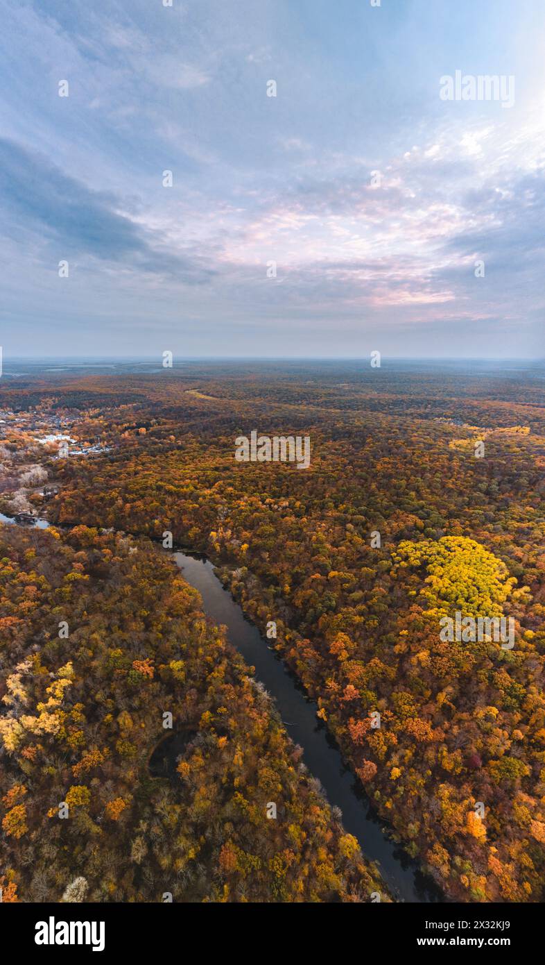 Aerial autumn river dale with golden forest on riverbanks and clouds ...