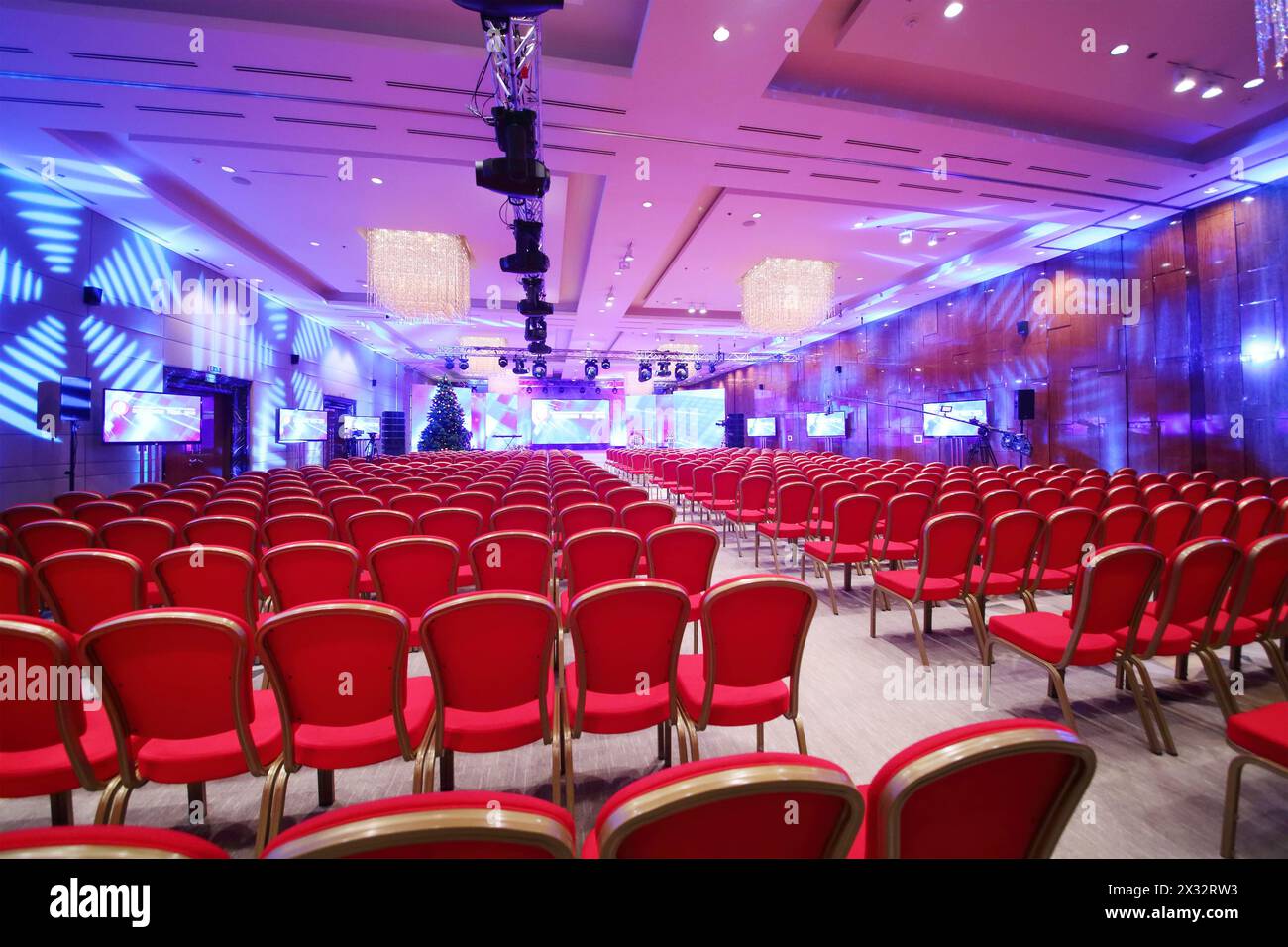 Conference hall with red chairs and colored illumination Stock Photo ...