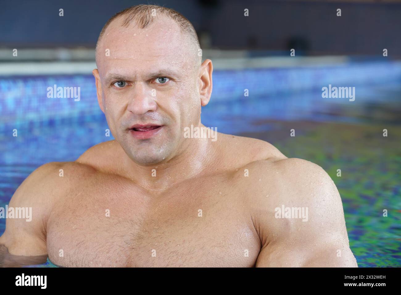 Close up of middle-aged bodybuilder standing in swimming pool Stock ...