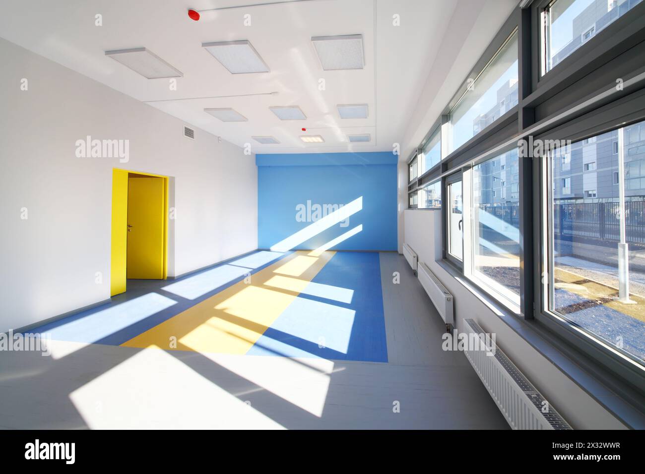 Group room with blue and white walls and large windows in the ...