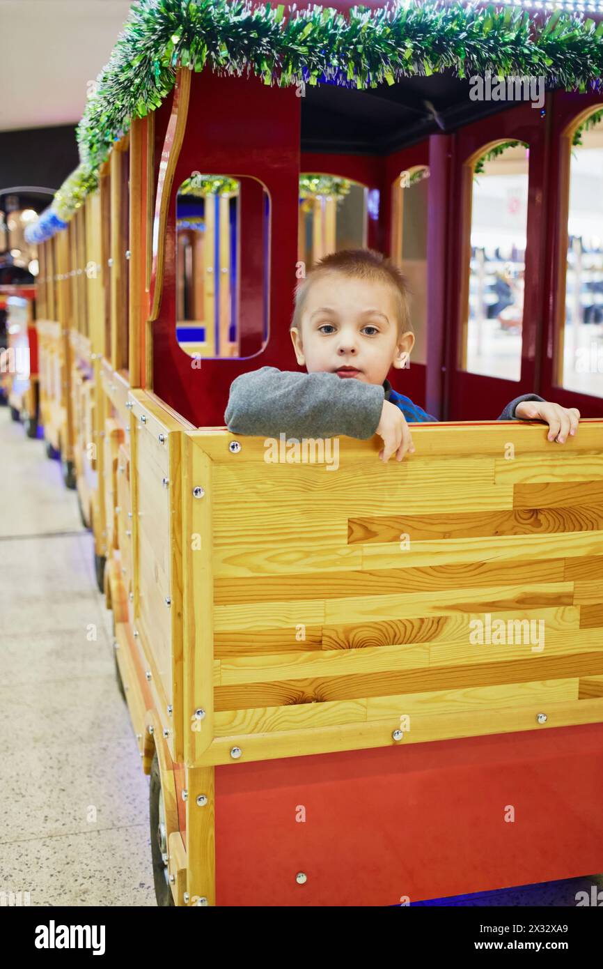 Little boy sits in wooden coach at children attraction Stock Photo - Alamy