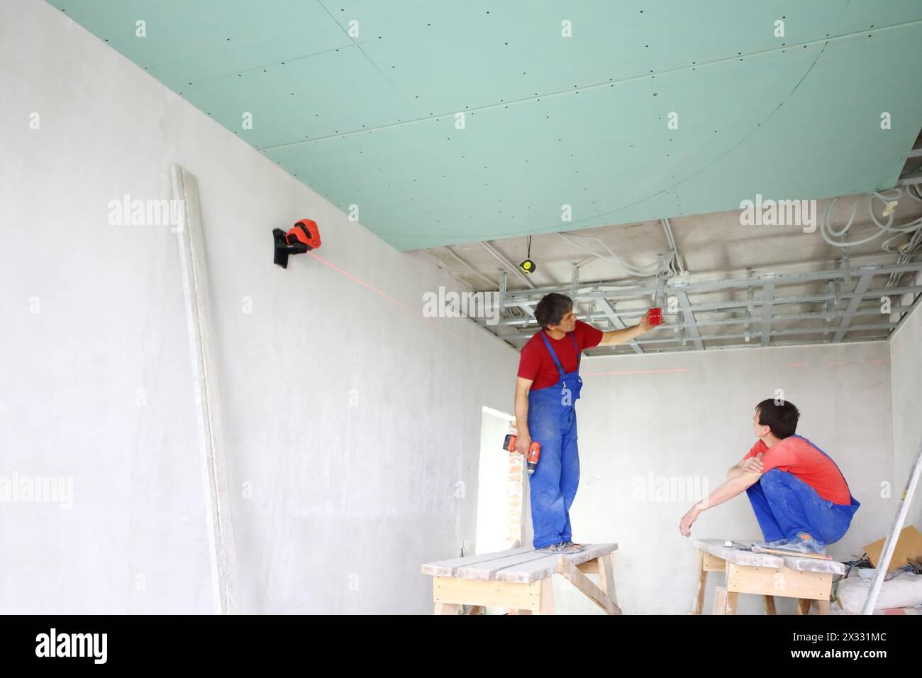 The builders install the ceiling profile in the new apartment Stock ...