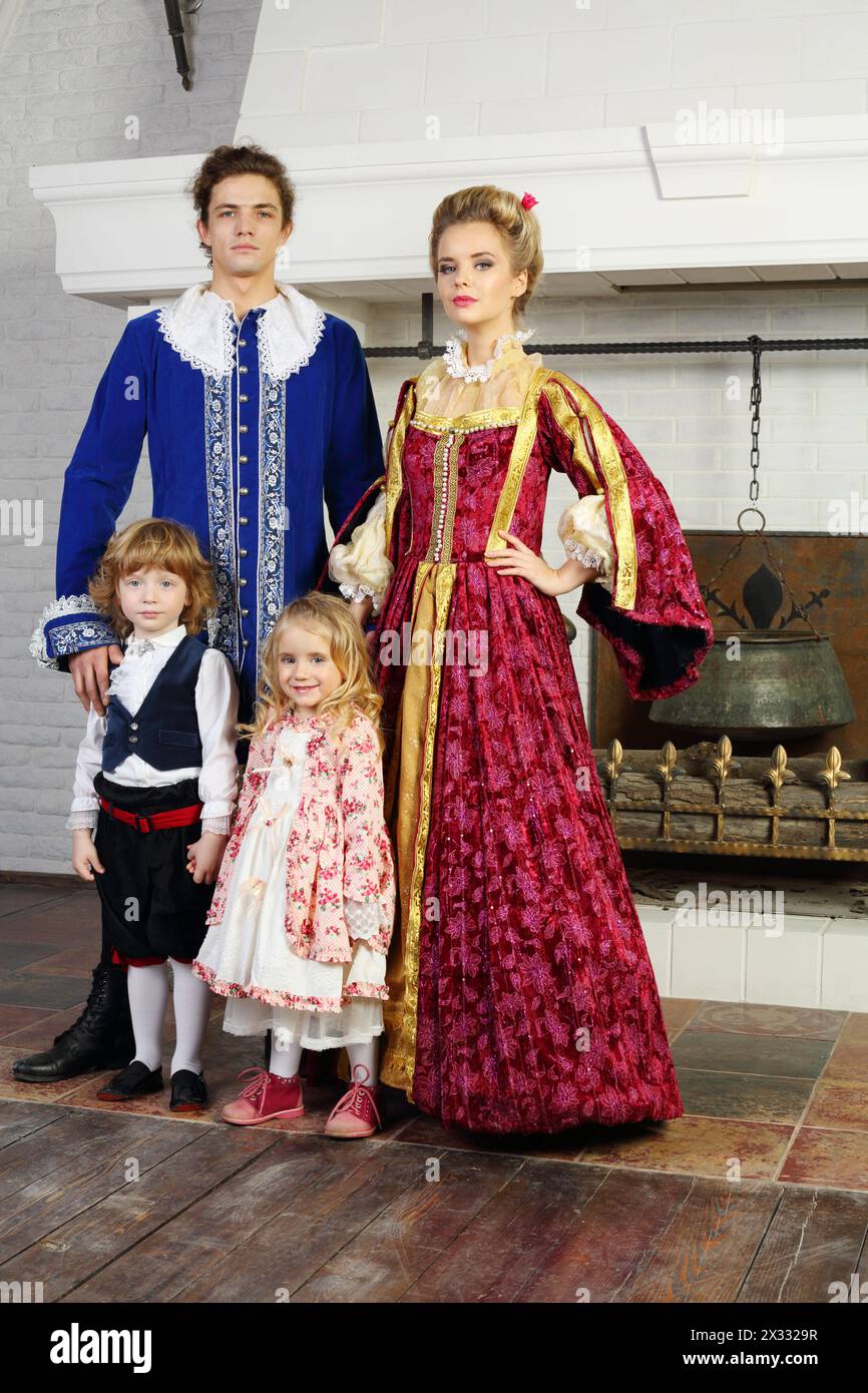 Father, mother, little daughter and son in medieval costumes stand near ...