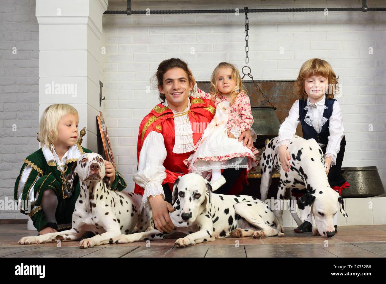Happy father in medieval costume with three children and three ...