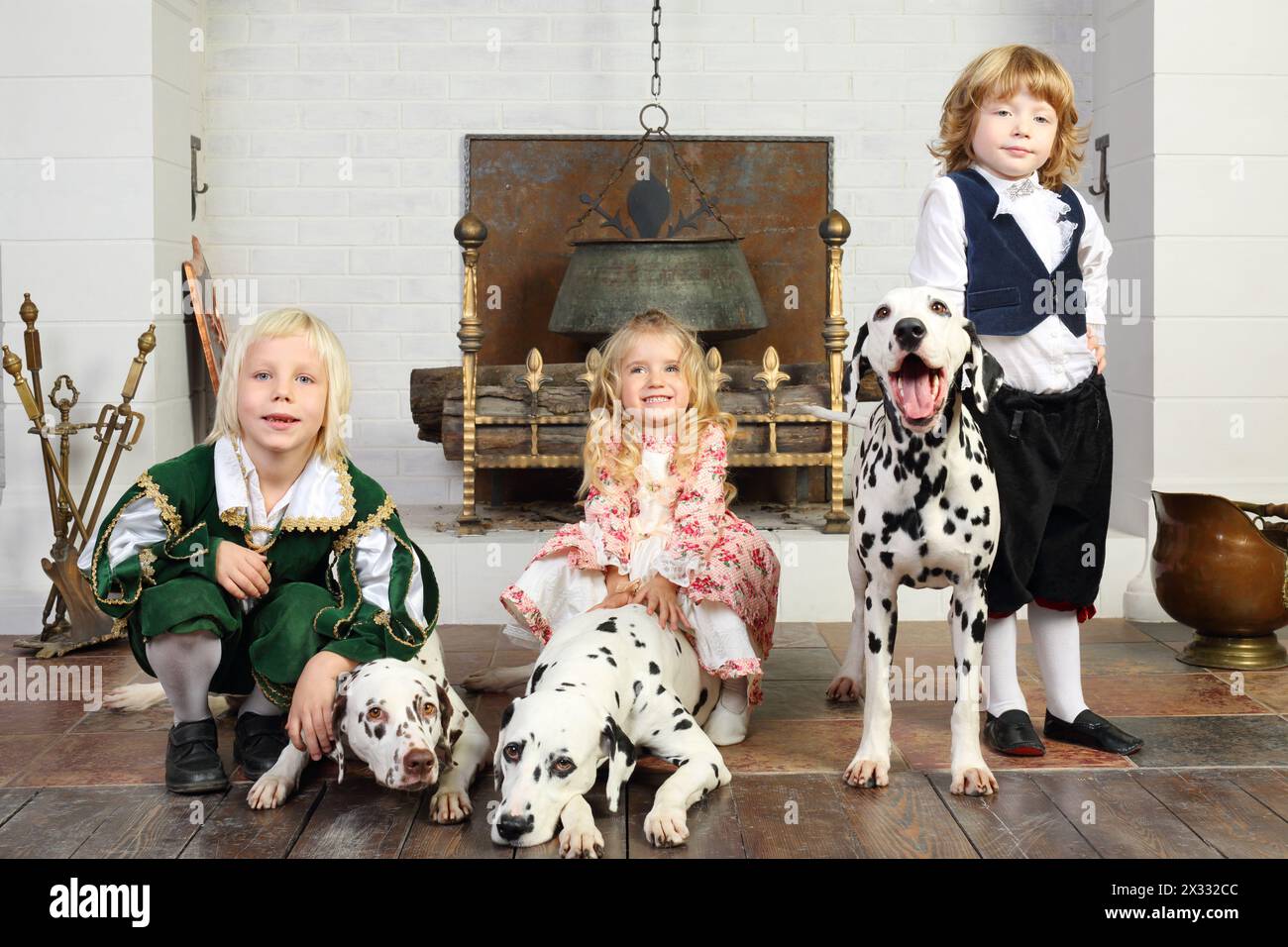 Two happy boys and little girl in medieval costumes with three ...
