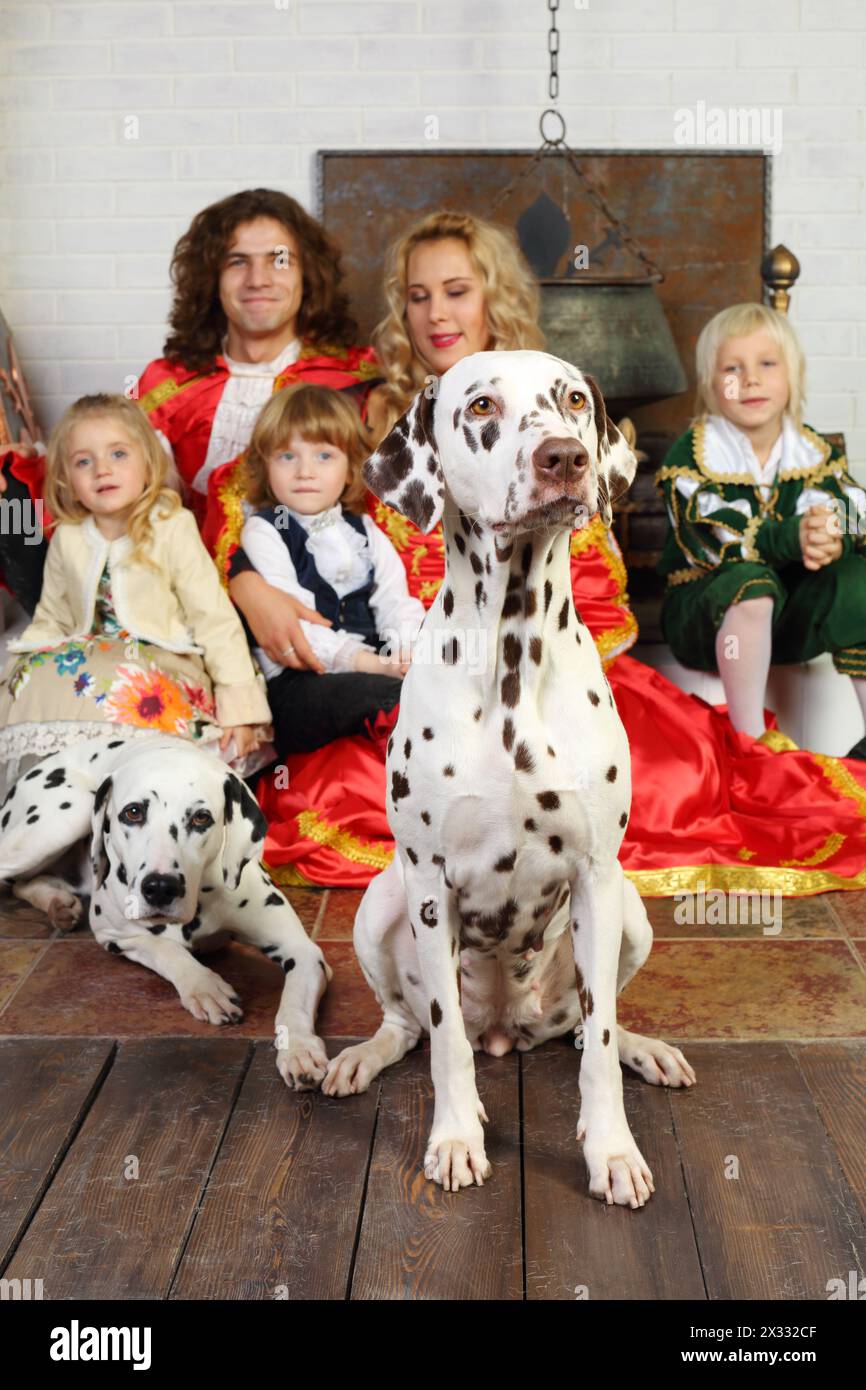 Father, mother, little daughter and two sons in medieval costumes sit ...