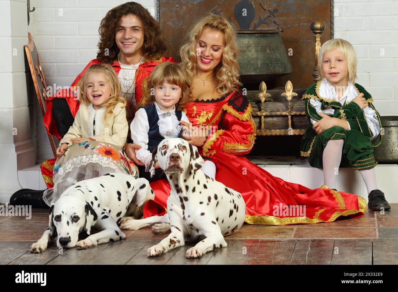 Happy father, mother, little daughter and two sons in medieval costumes ...