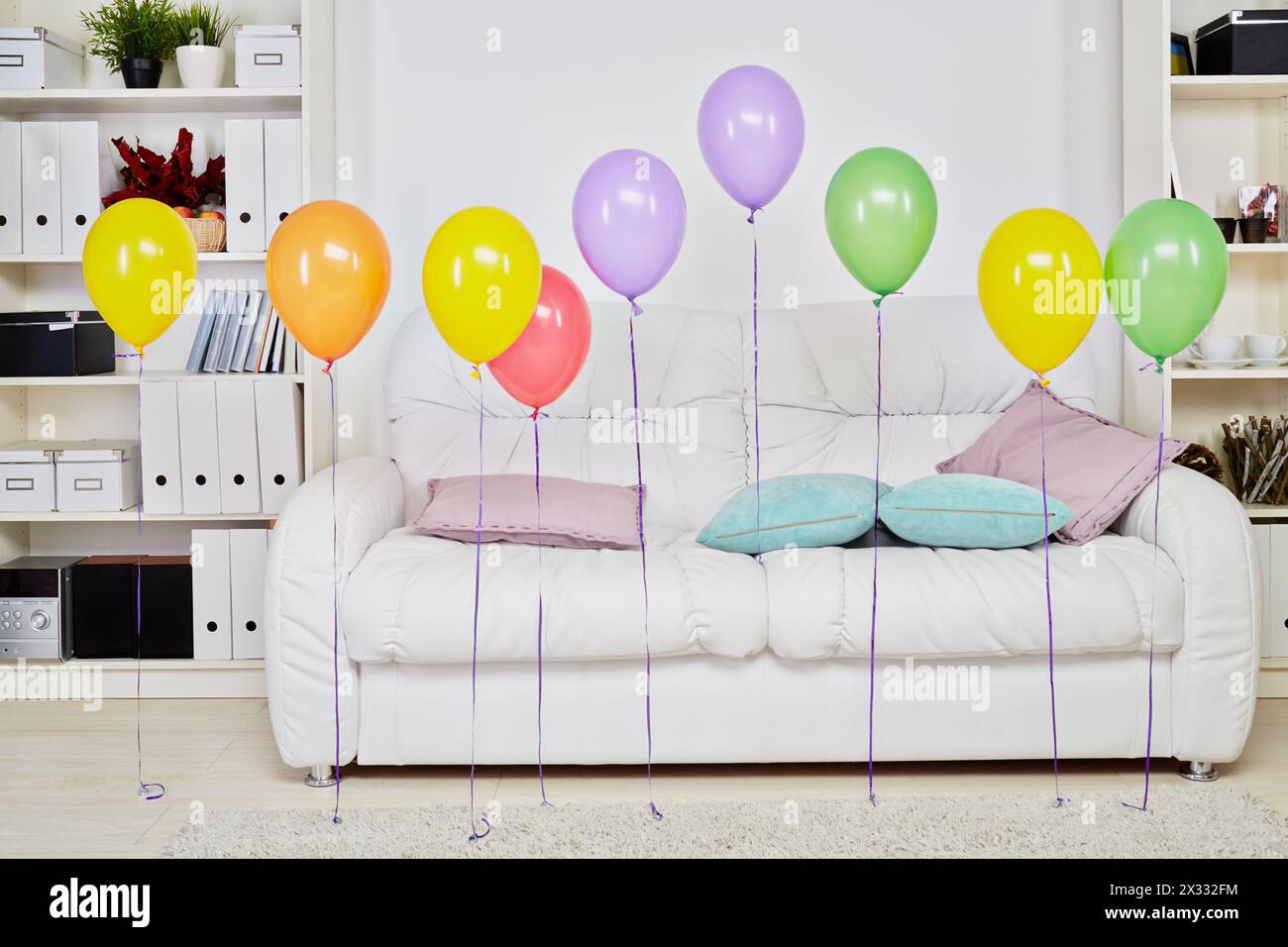 Interior of room with big soft white sofa, light carpet on floor and ...