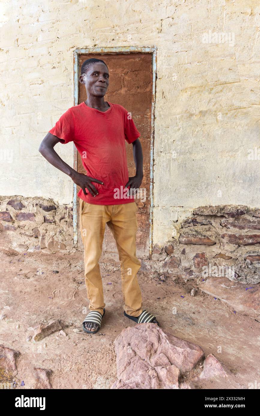 profile view of a happy single young village african man sited in front ...