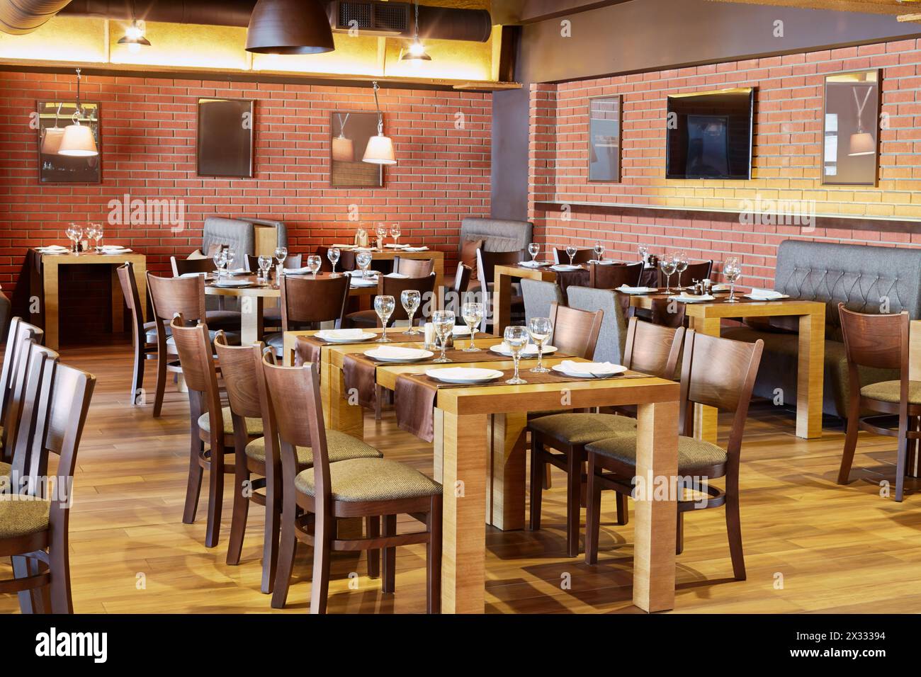 Restaurant room with wooden furniture and walls of red bricks Stock ...