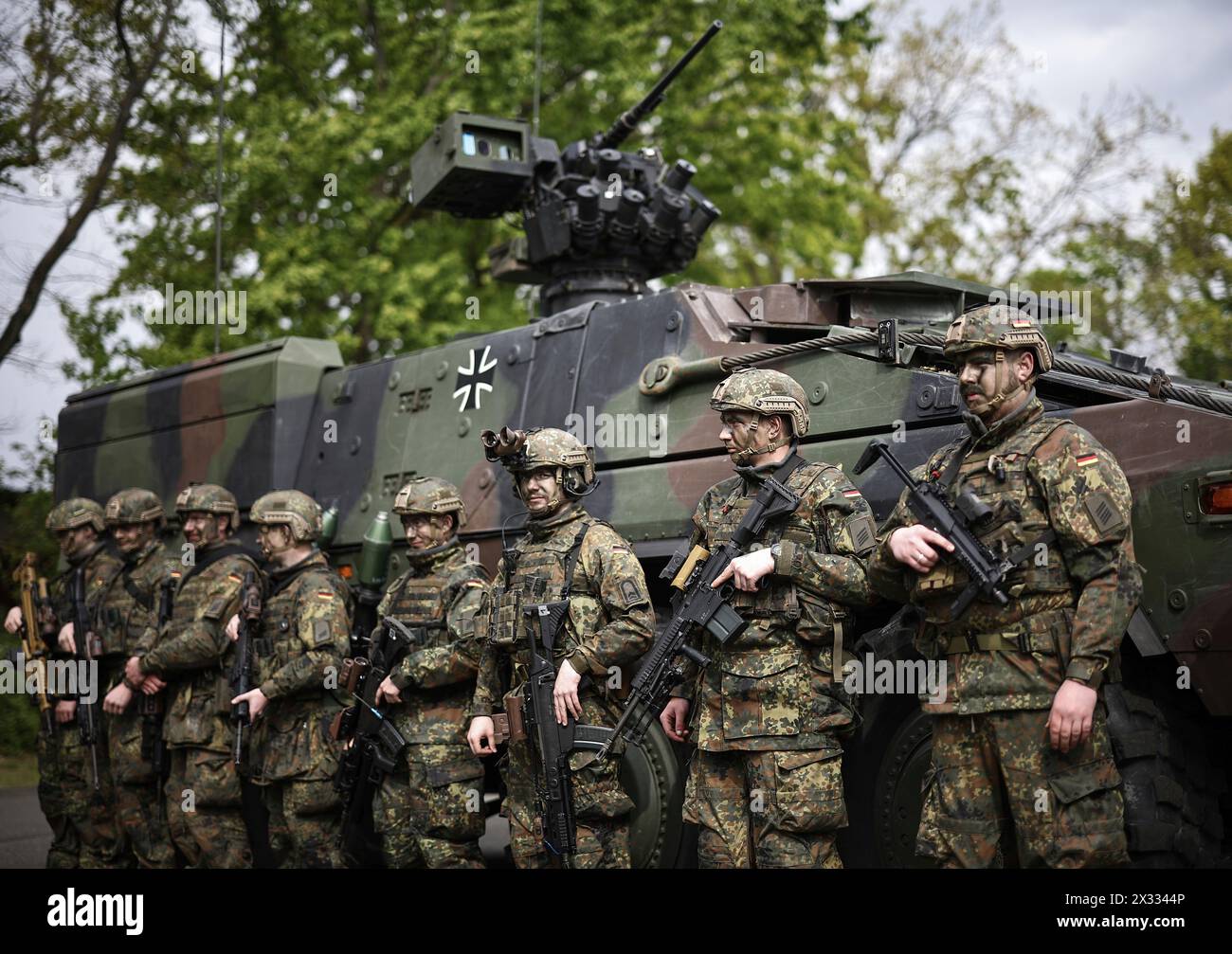 Soldiers of the German forces, Bundeswehr, stand in front of a Boxer ...