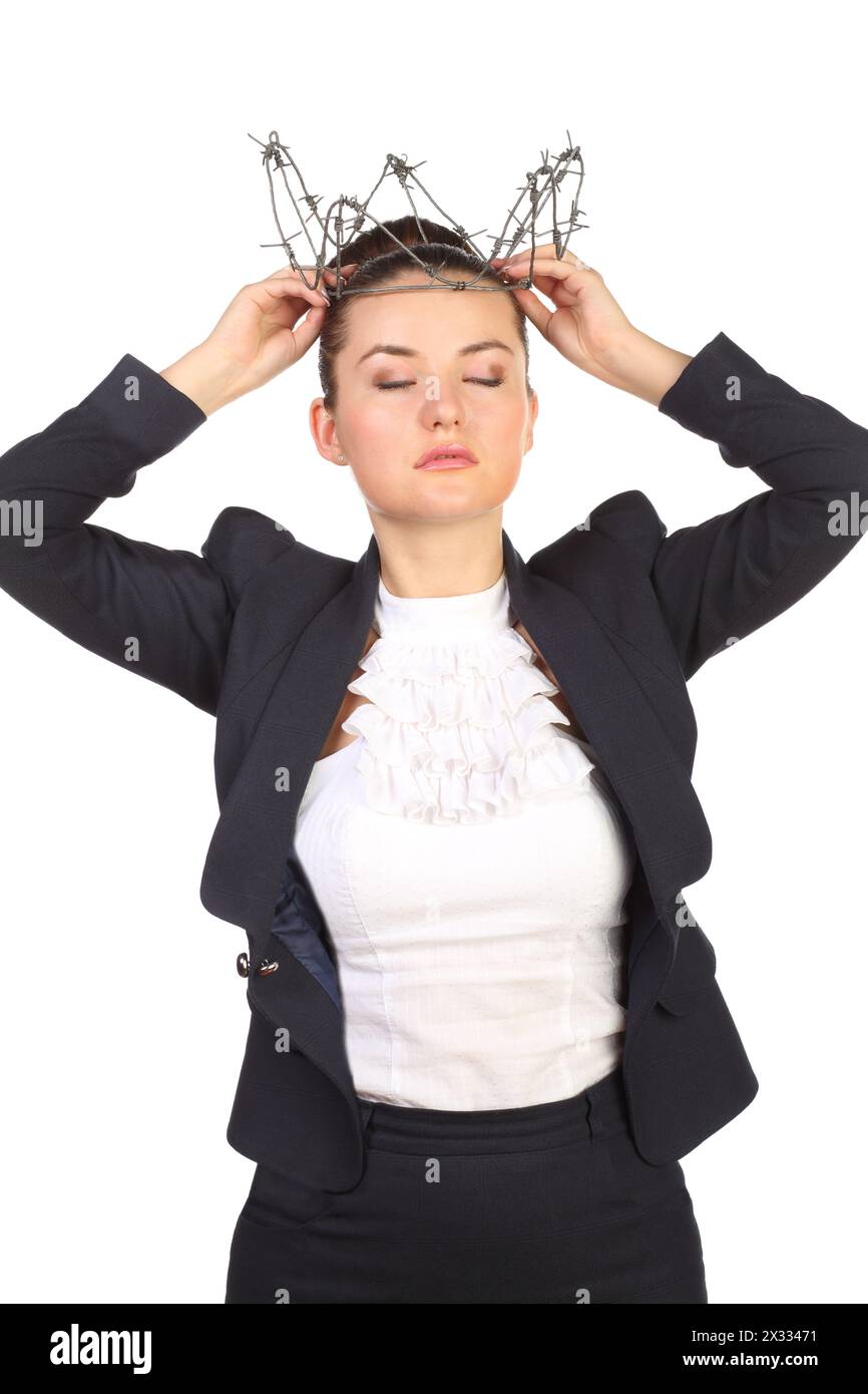 Beautiful woman in black suit with eyes closed trying crown of barbed ...