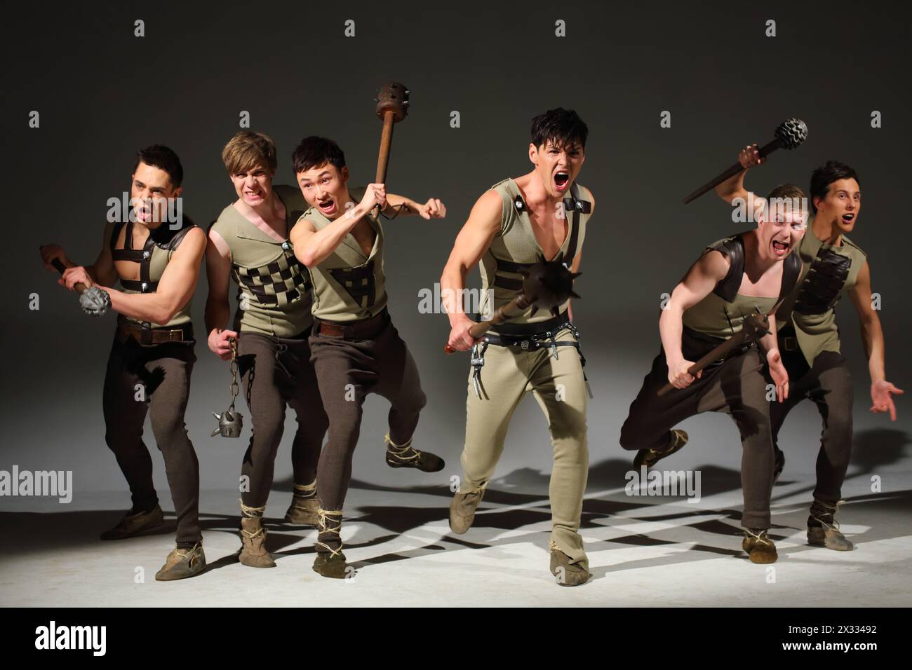 Group of strong young men running and screaming with maces in their ...