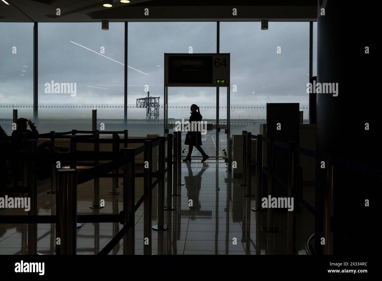 Silhouette of a woman waiting at the boarding gate of Terminal 1, Paris ...