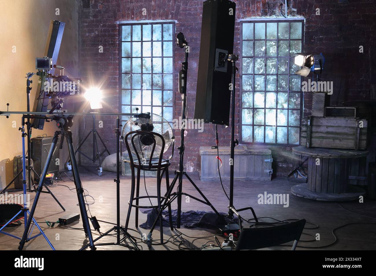 Studio with studio with brick walls and ragged windows, spotlights ...