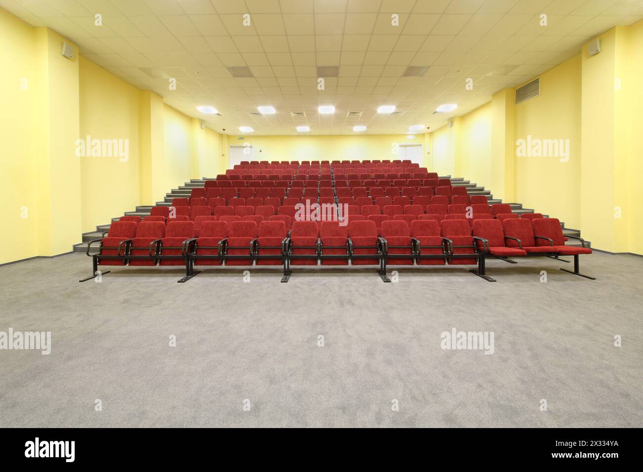 Small empty concert hall with red armchairs and yellow walls Stock ...