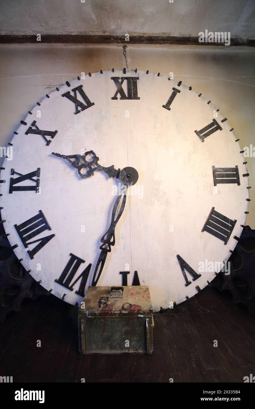 Big white clock with Roman dial stands in room with wooden floor Stock ...