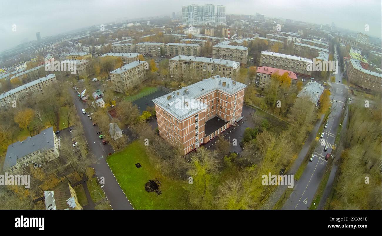 Road with cars acrossed residential areas with school, view from ...