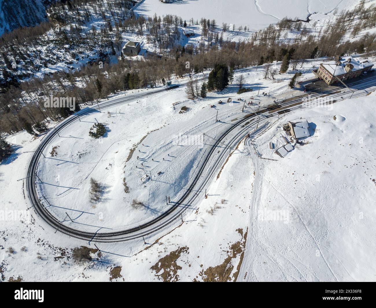 Aerial image of the Rhaetian Railway track with the famous tight 180° curve at high Alp Grum ...