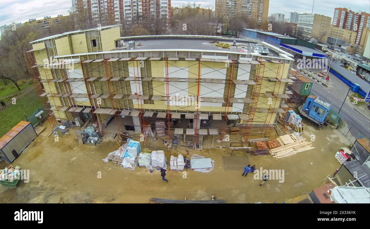 Builders are working on facing of the new building, view from unmanned ...