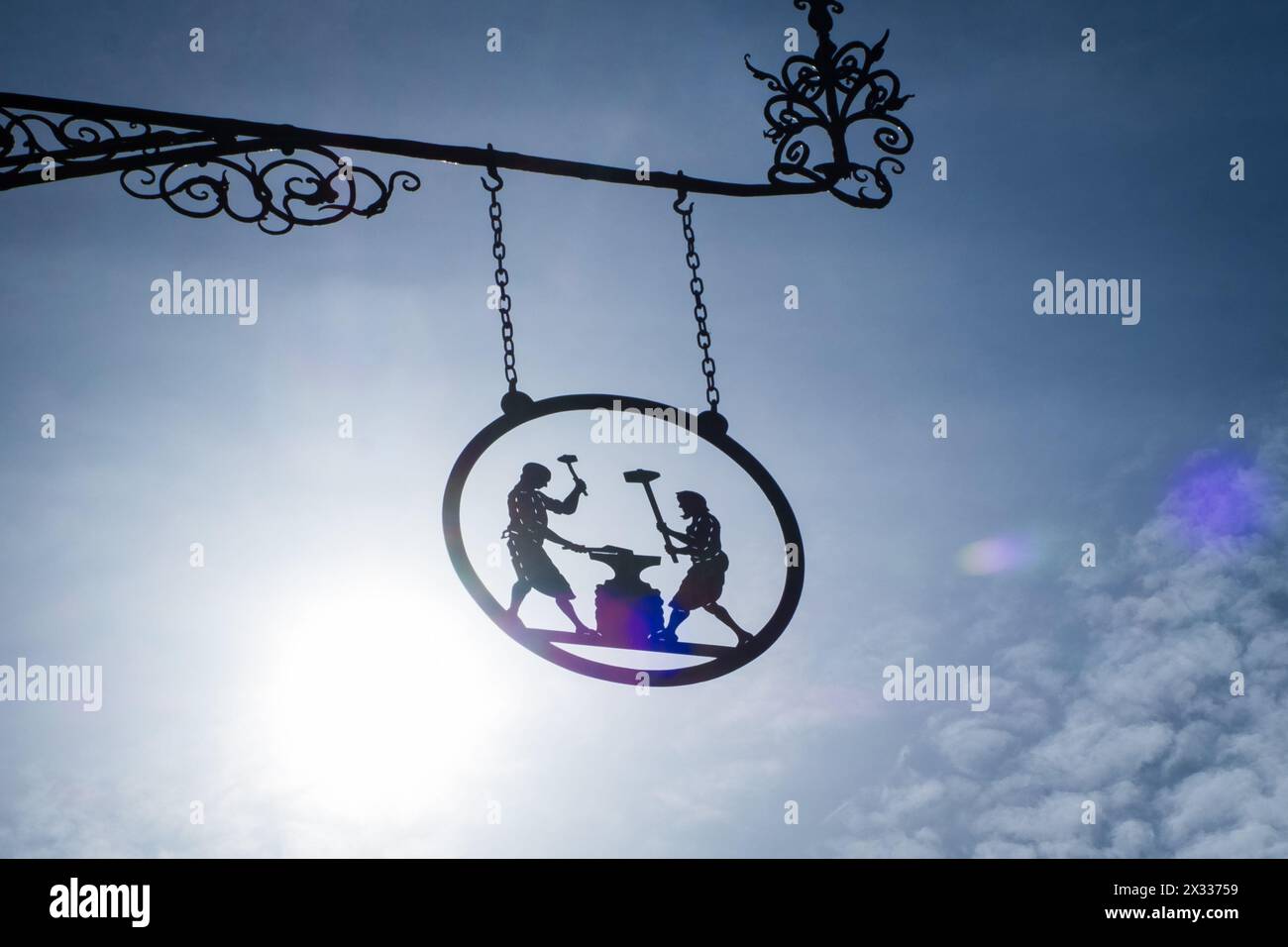 Hanging sign on a blacksmith workshop building Stock Photo - Alamy