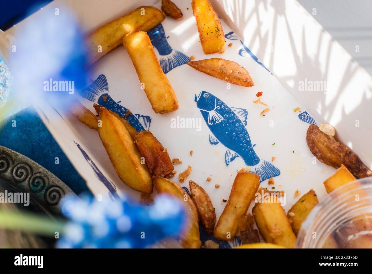 Box of crispy chips with cute fish design peeking through. Food box ...