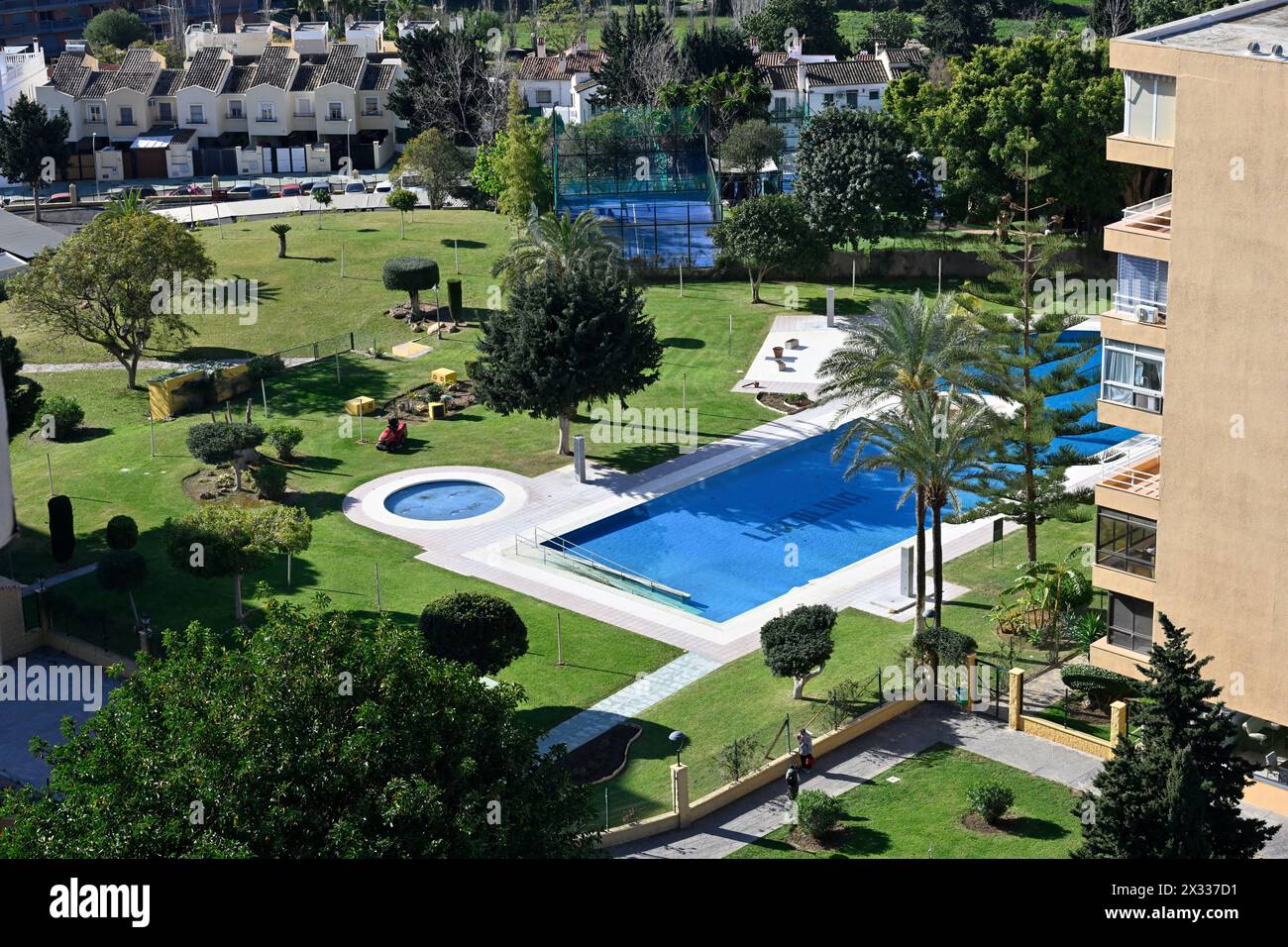 Swimming pool and gardens in grounds of apartment building in ...