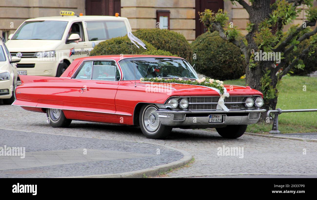Early 1960s red two-door hardtop Cadillac, decorated with ribbons and ...
