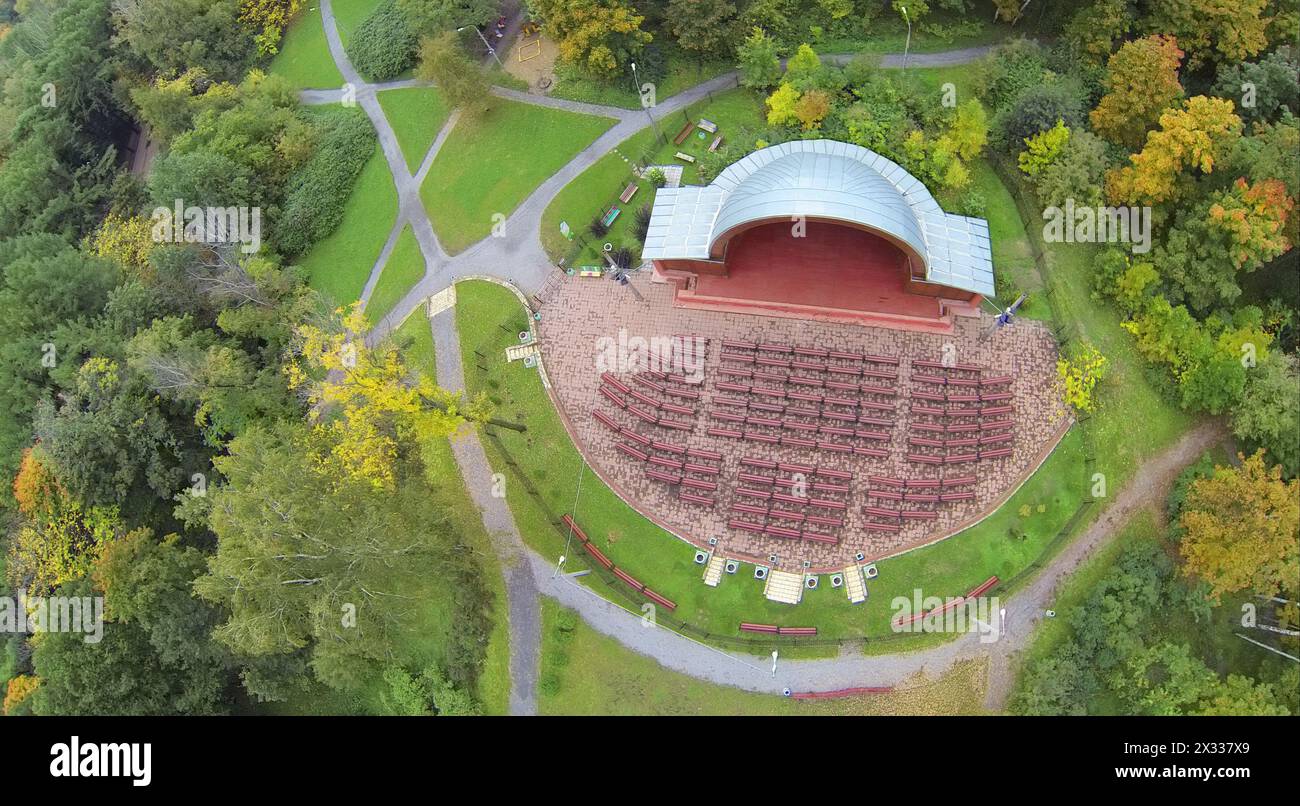 Outdoor amphitheater in autumn park. View from unmanned quadrocopter ...