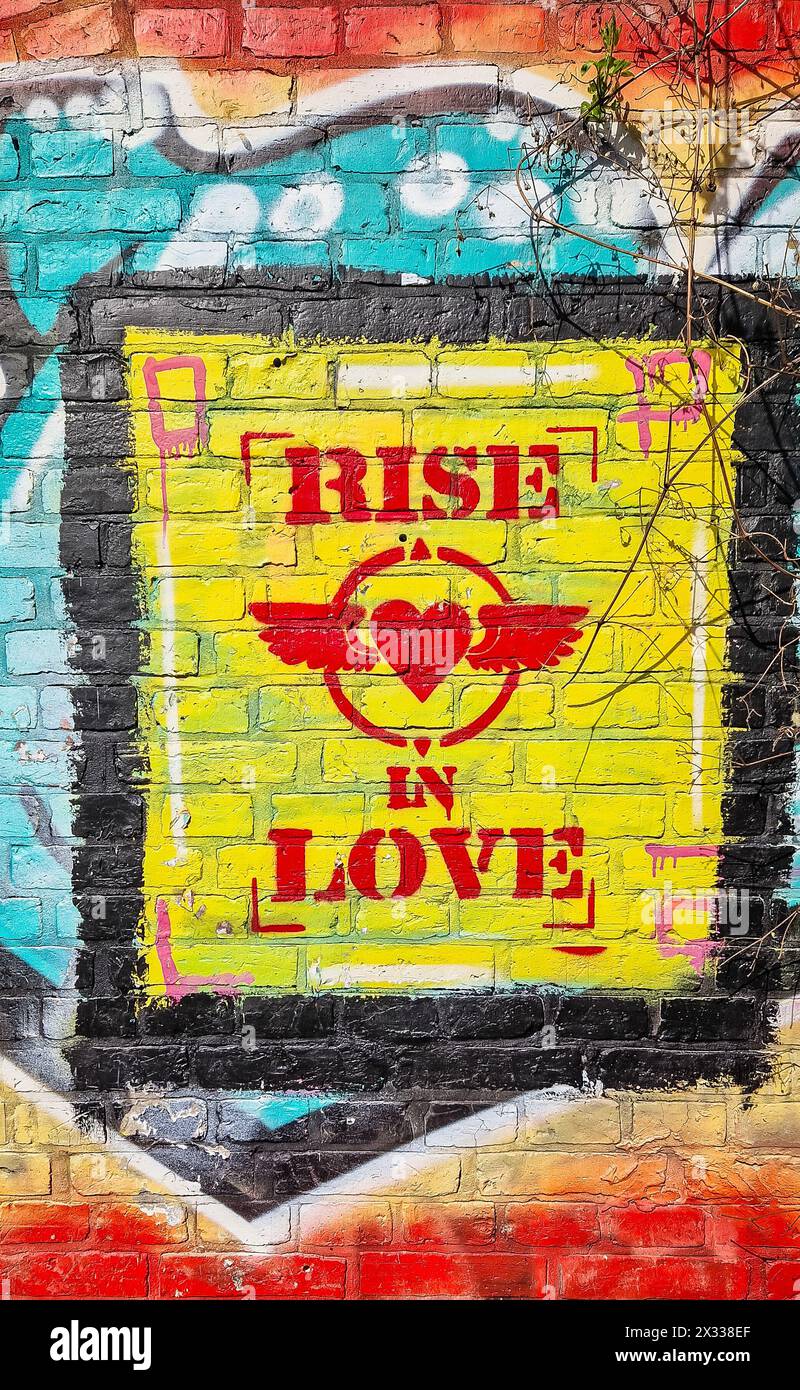 Wall drawing saying "Rise in love Stock Photo - Alamy