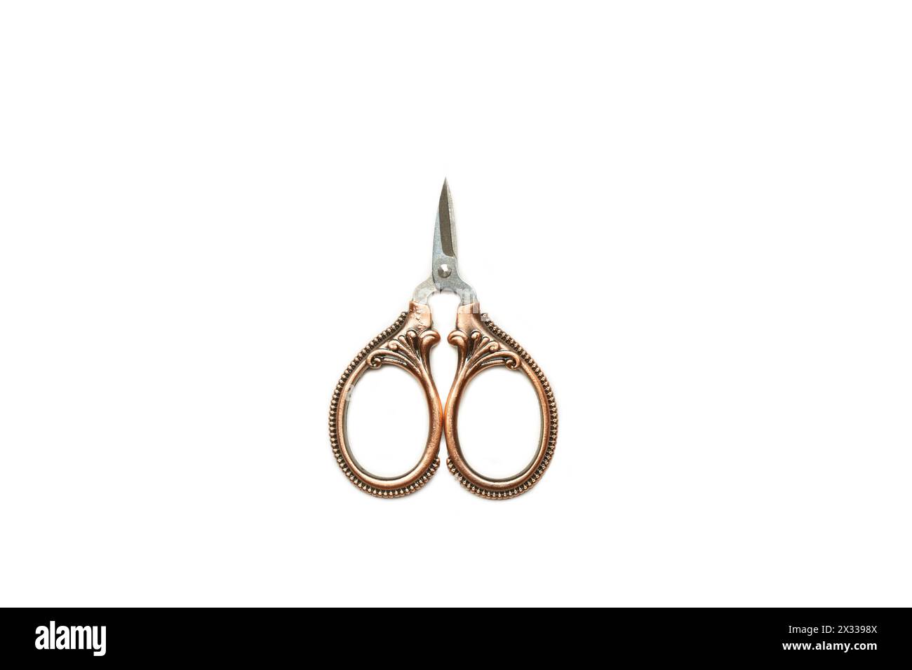 Small scissors with large golden handles on a white background Stock ...