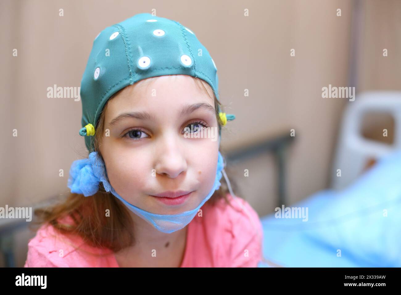 Portrait of girl in a special cap for electroencephalography in the ...