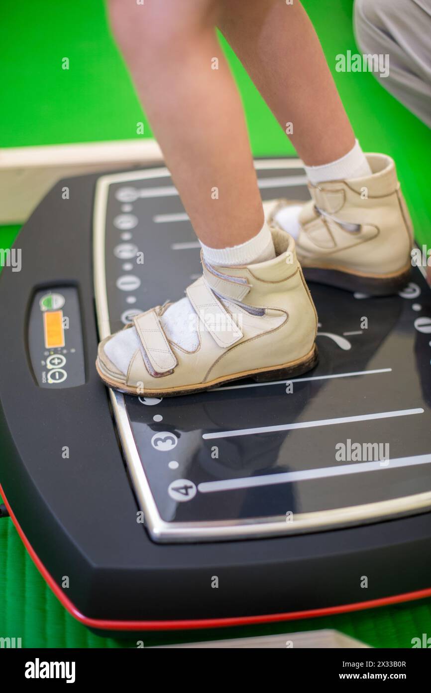 child feet on a vibrating training platform Stock Photo - Alamy
