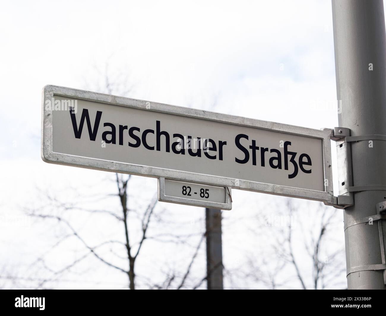 Warschauer Straße street sign in Berlin. Road name guide at an ...