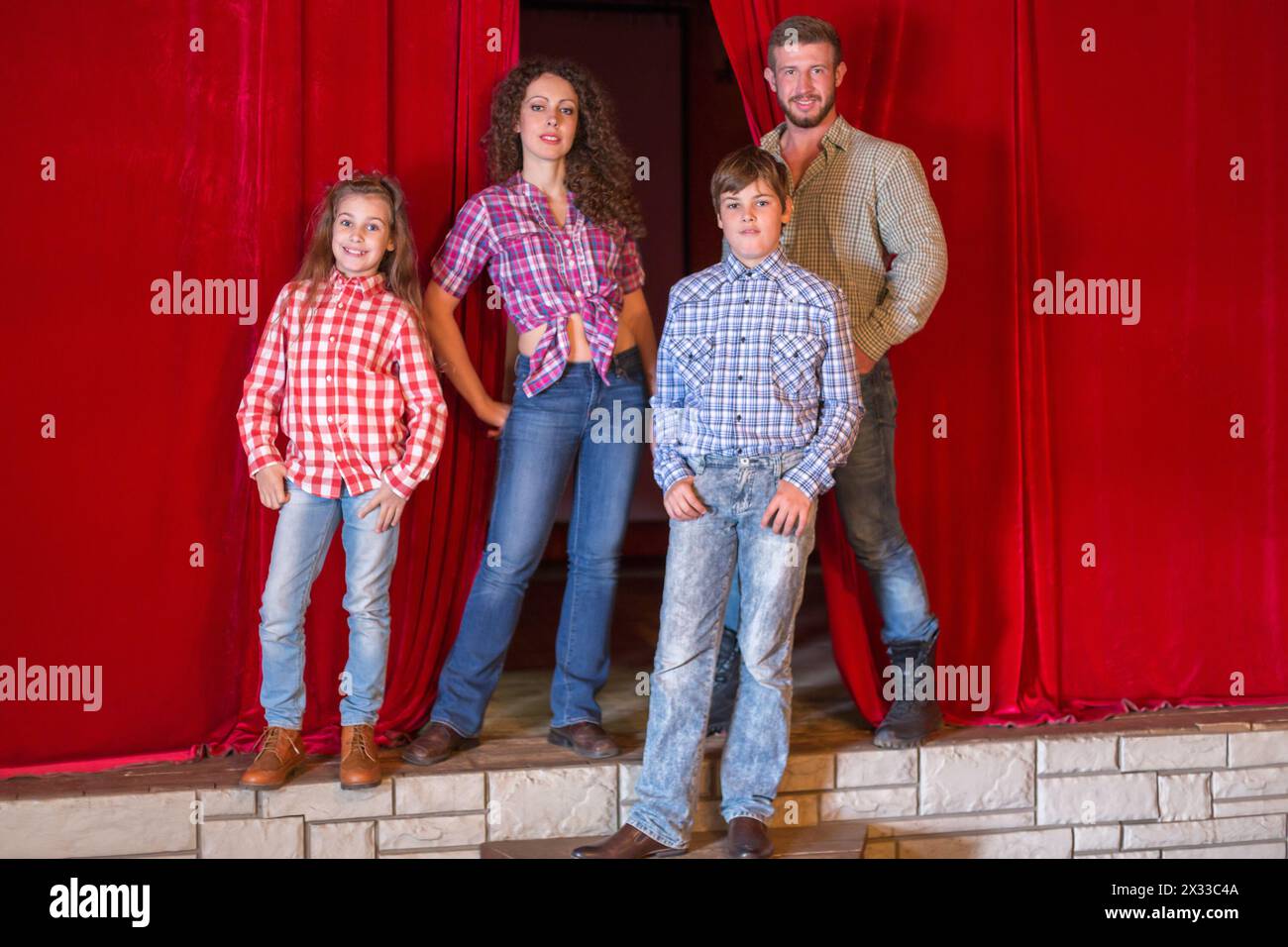 family of four standing on a saloon stage Stock Photo - Alamy