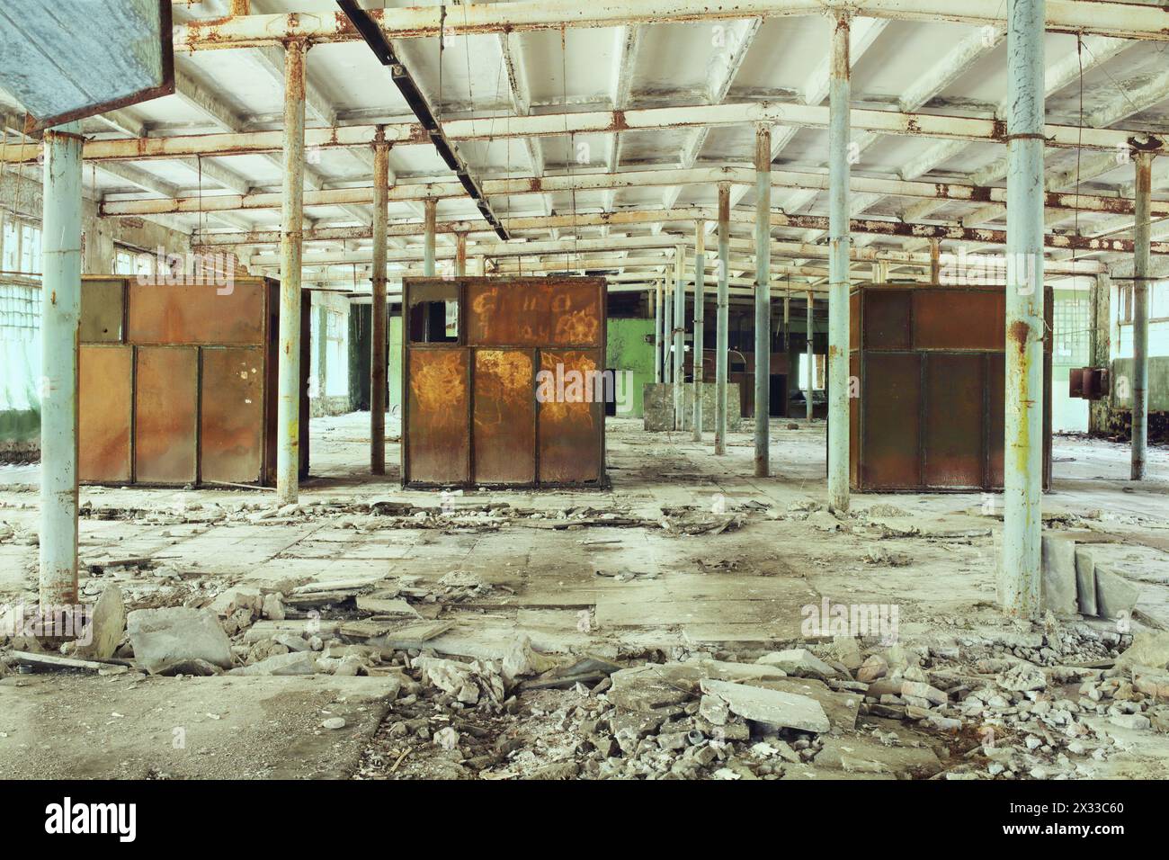 interior of abandoned building with columns and broken concrete floor ...