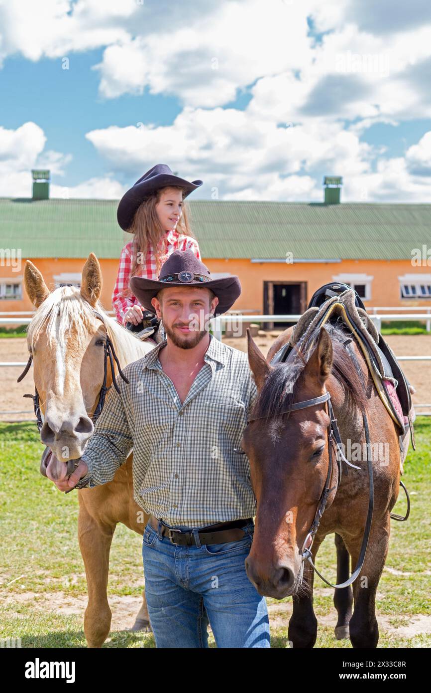 cowboy father rolls his daughter on a horse Stock Photo - Alamy