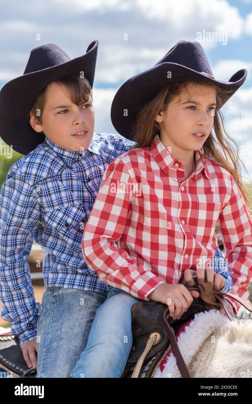 cowboy brother and sister closeup portrait on horseback Stock Photo - Alamy