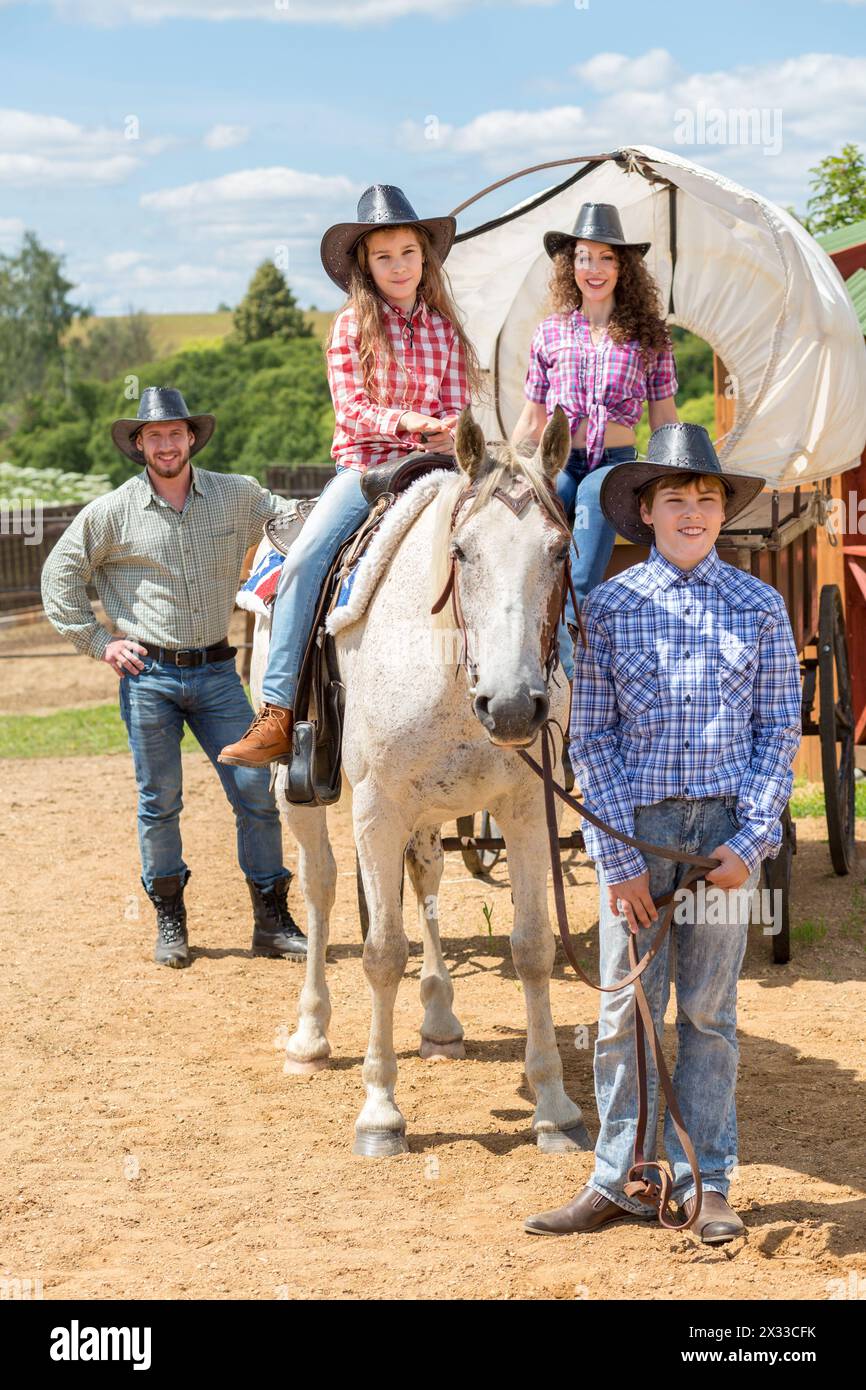 cowboy family of four with wagon and horse Stock Photo - Alamy