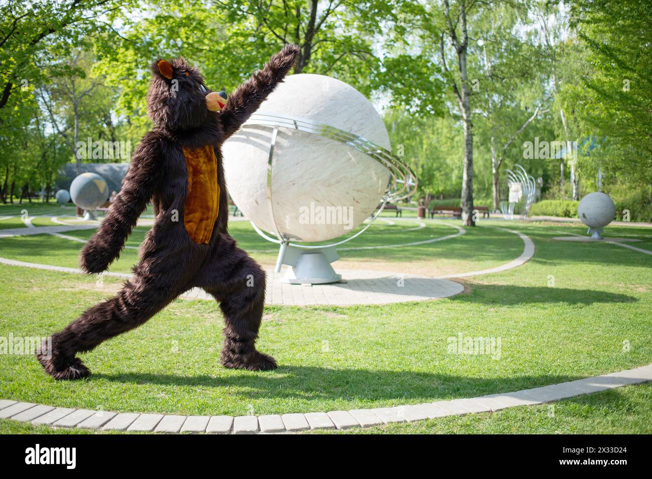 actor dressed as bear aerobics near sculptural model of solar system ...