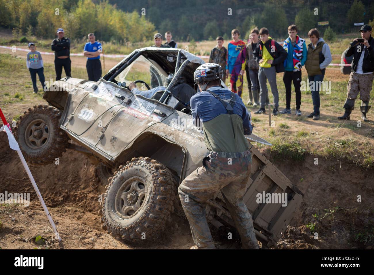 RUSSIA, PUSHKINO – 20 SEP, 2014: Rally team member is helping to pull ...