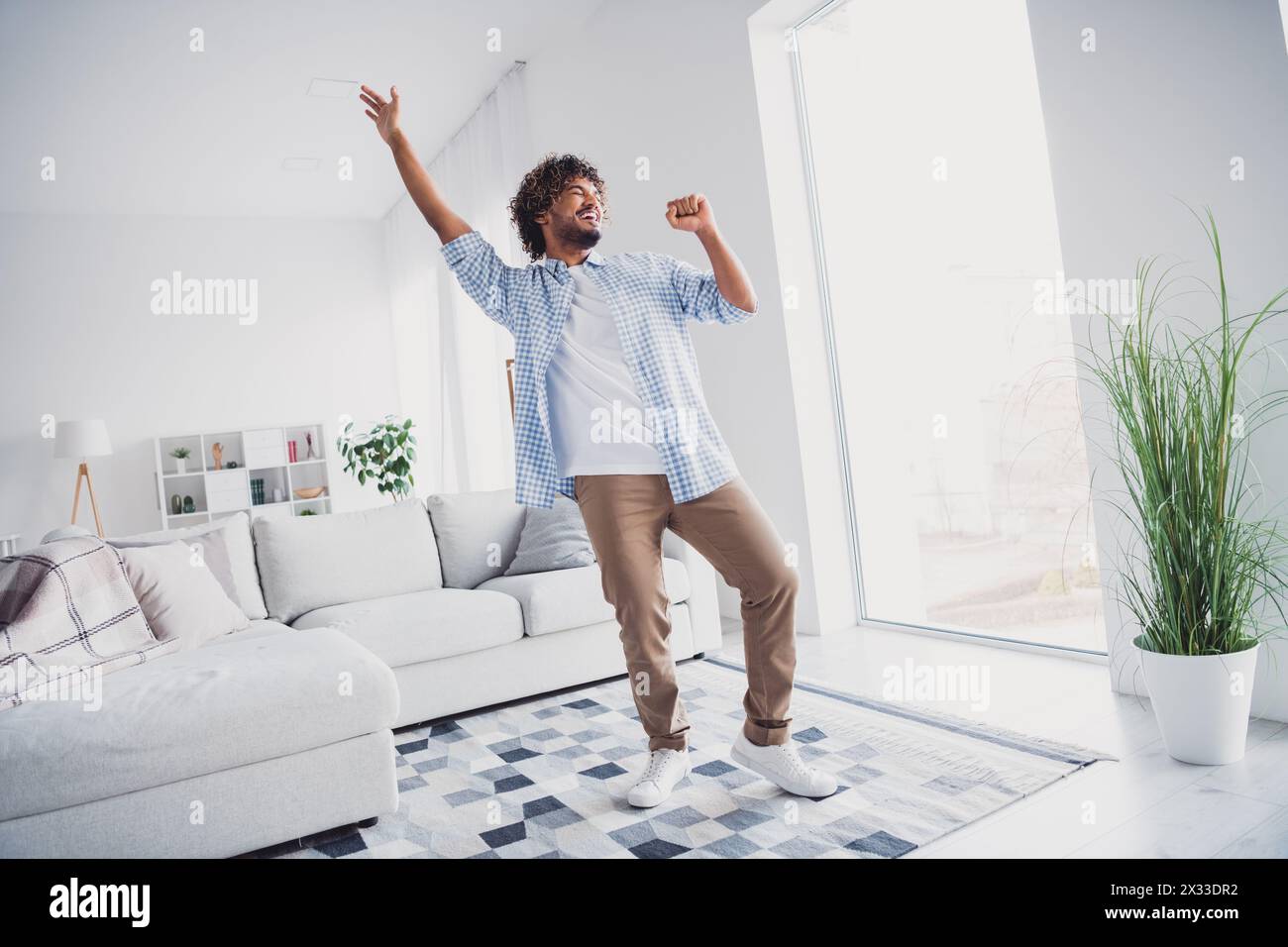 Photo of cheerful positive guy dressed plaid shirt dancing singing mic ...