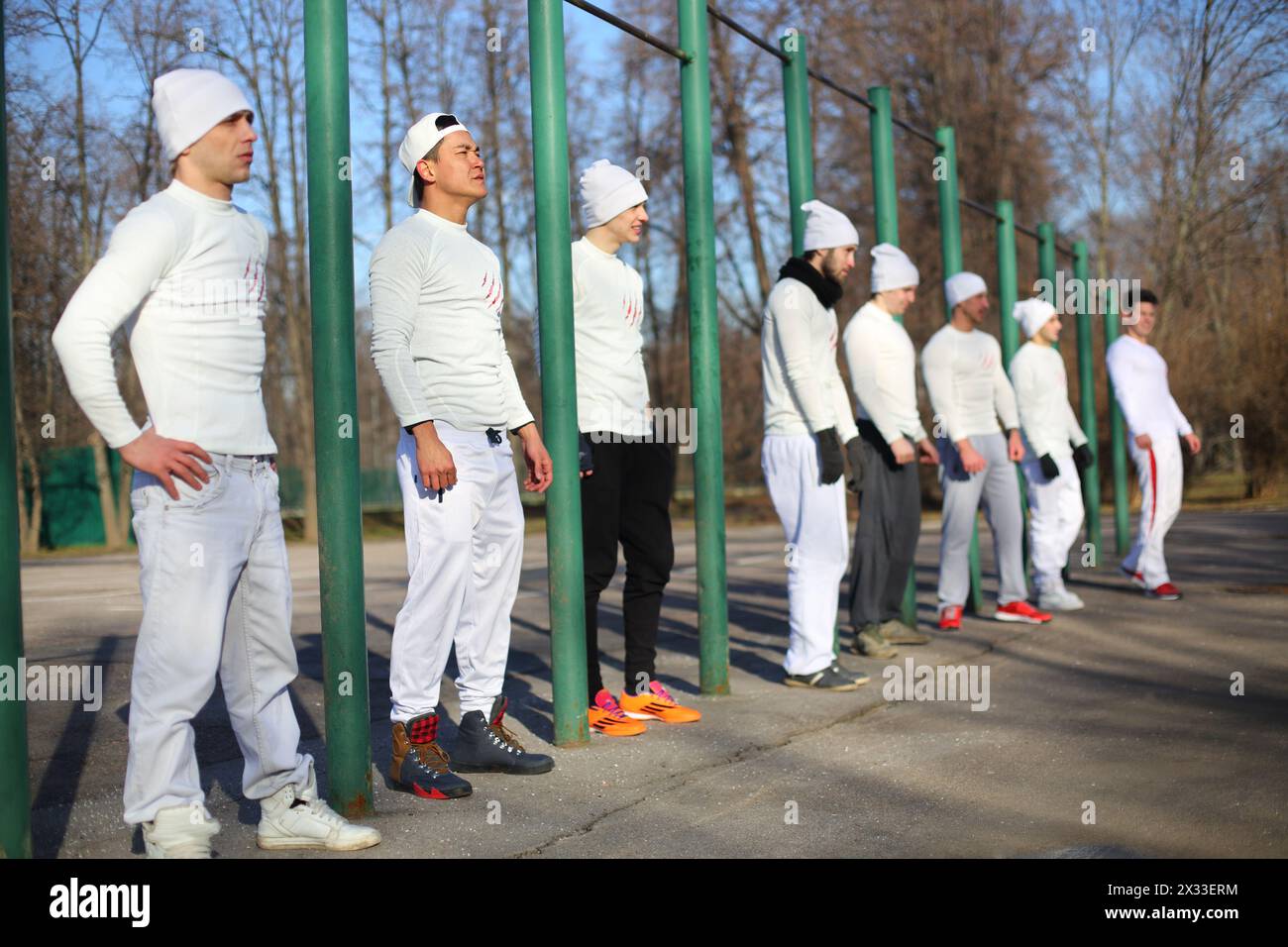 Eight young men near the long horizontal bar at the playground Stock ...
