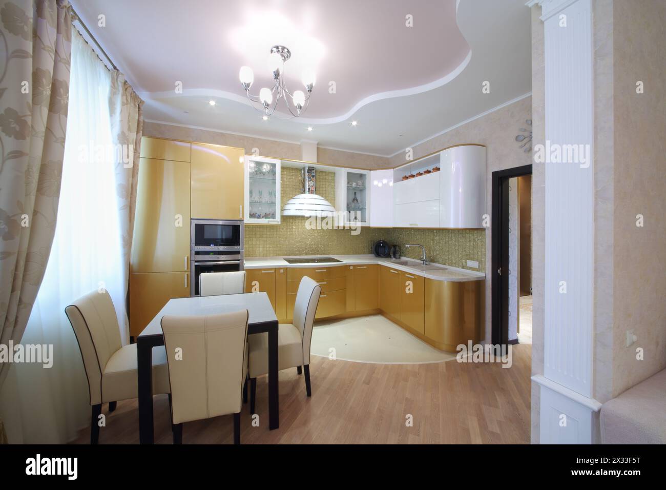 Interior of luxurious kitchen with golden cabinets in the apartment ...